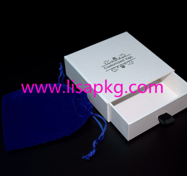 white drawer box with pink velvet bag